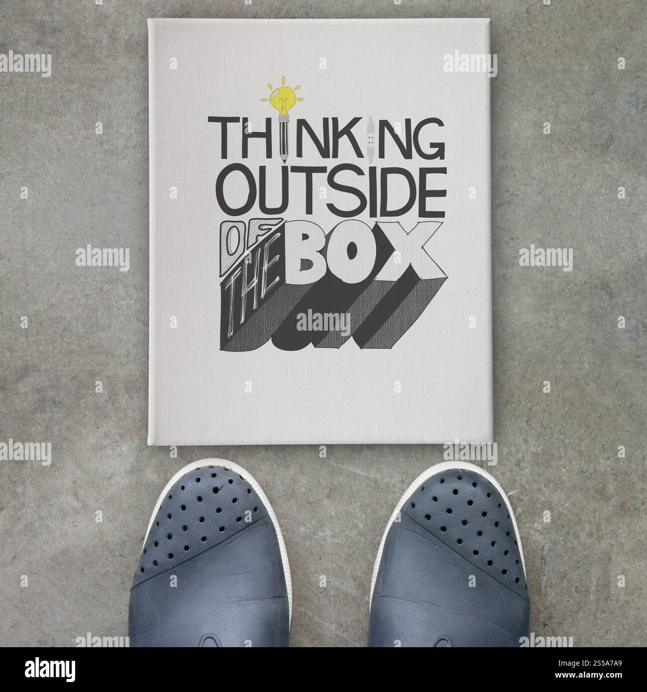 design word THINKING OUTSIDE OF THE BOX on canvas board on front of ...