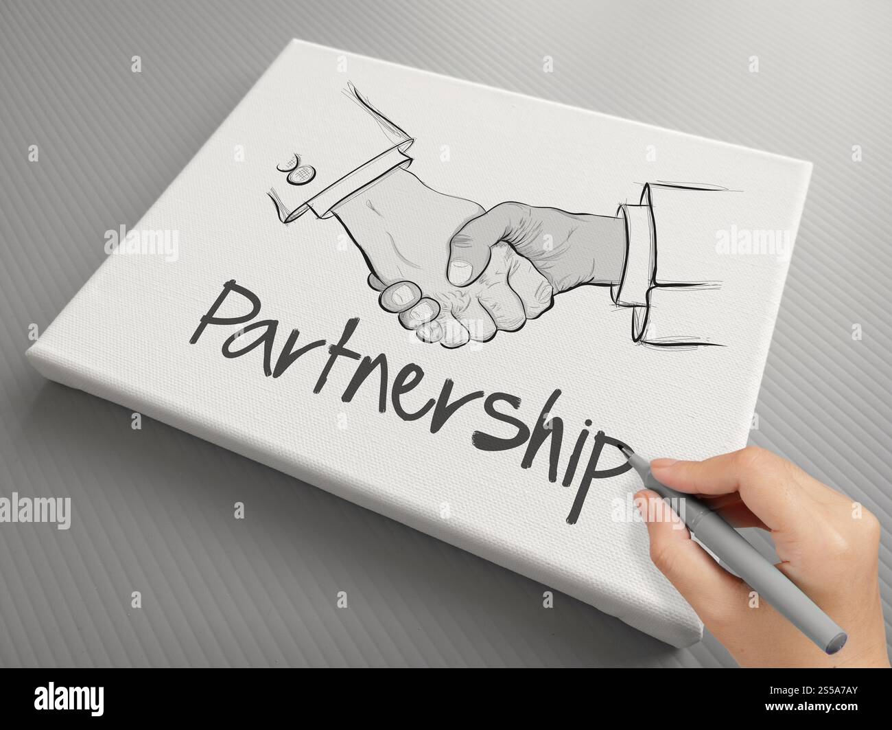 hand drawn handshake sign on canvas board as partnership business ...