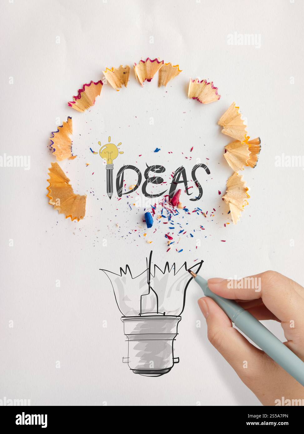 hand drawn light bulb word design IDEA with pencil saw dust on paper ...