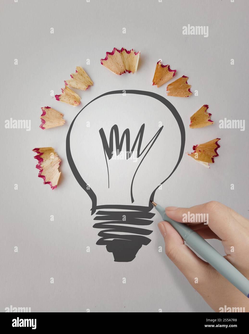hand drawn light bulb with pencil saw dust on paper background as ...
