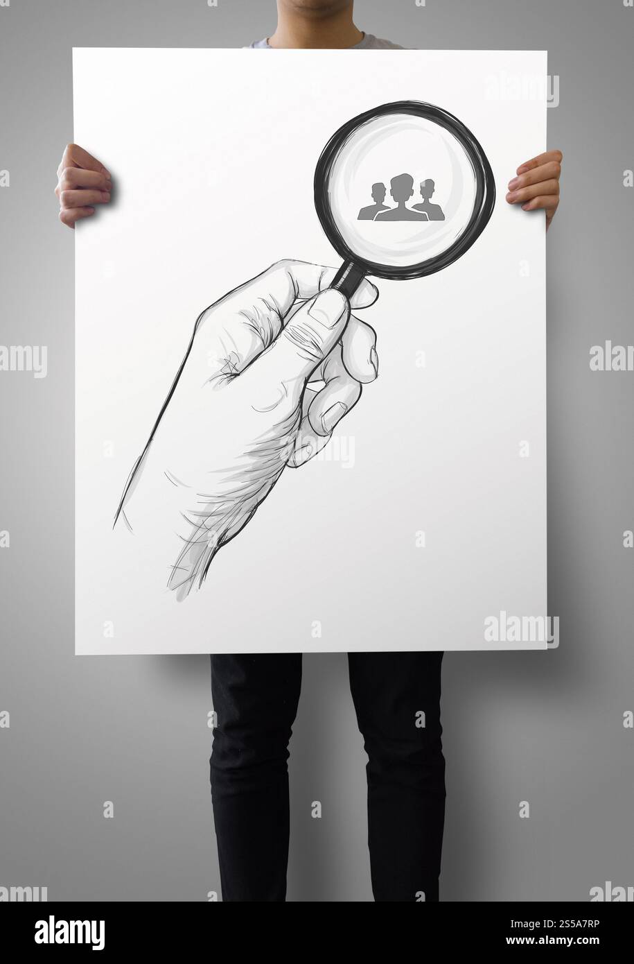 man showing poster of drawing of hand holding magnifier glass looking ...