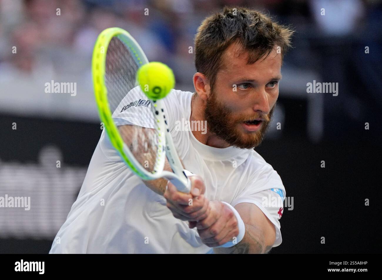 Corentin Moutet of France plays a backhand return to Alexei Popyrin of ...