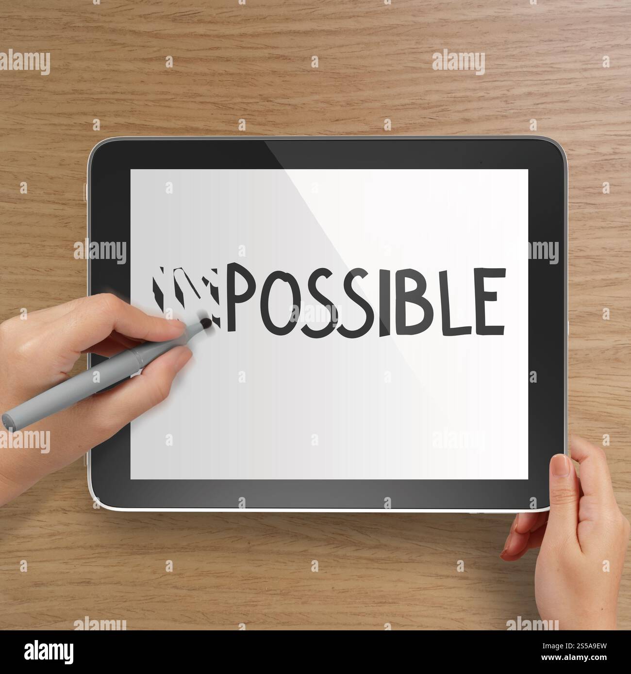hand changing the word impossible to possible with stylus eraser on ...