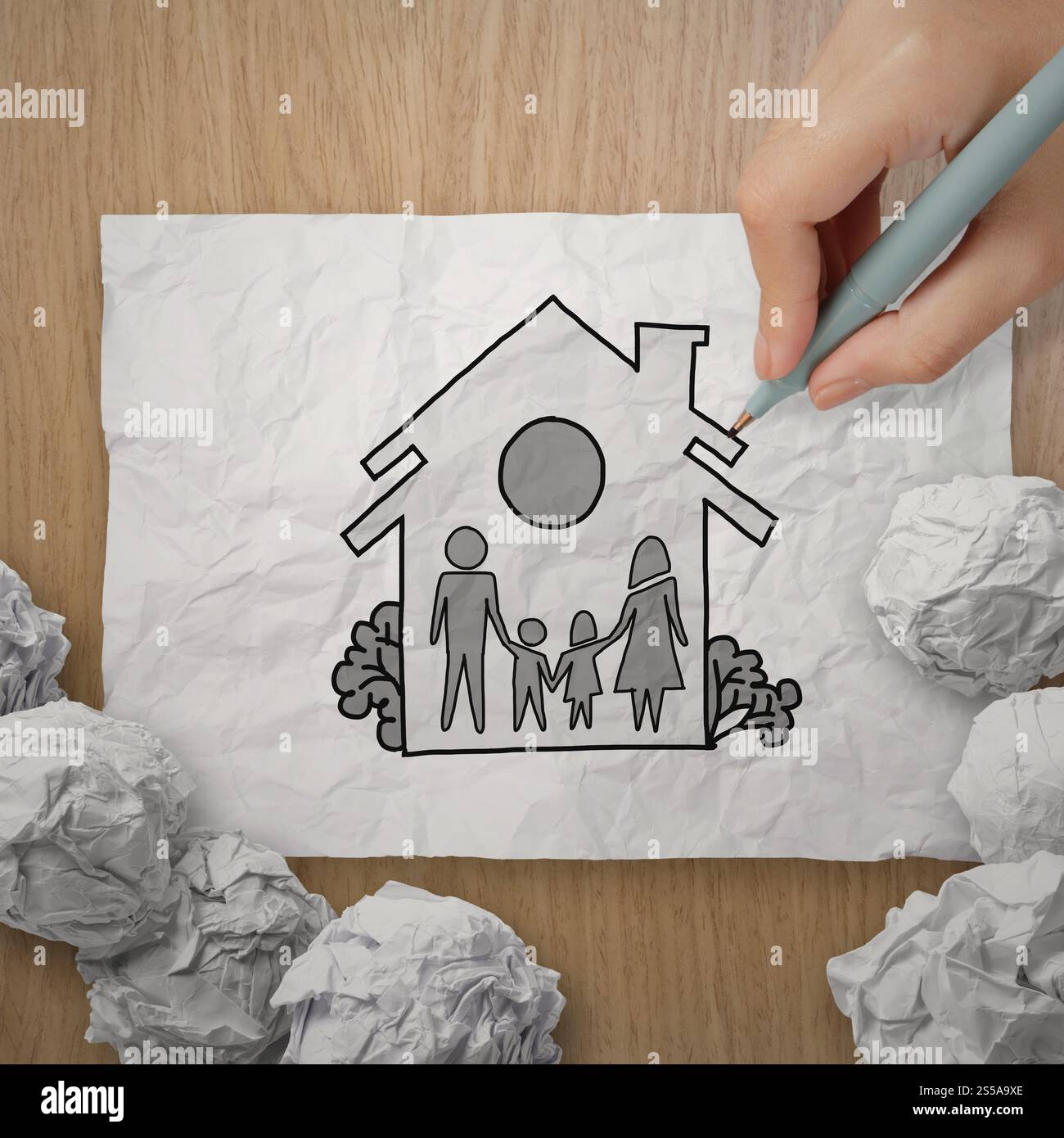 hand draw family and house on crumpled paper as insurance concept Stock ...