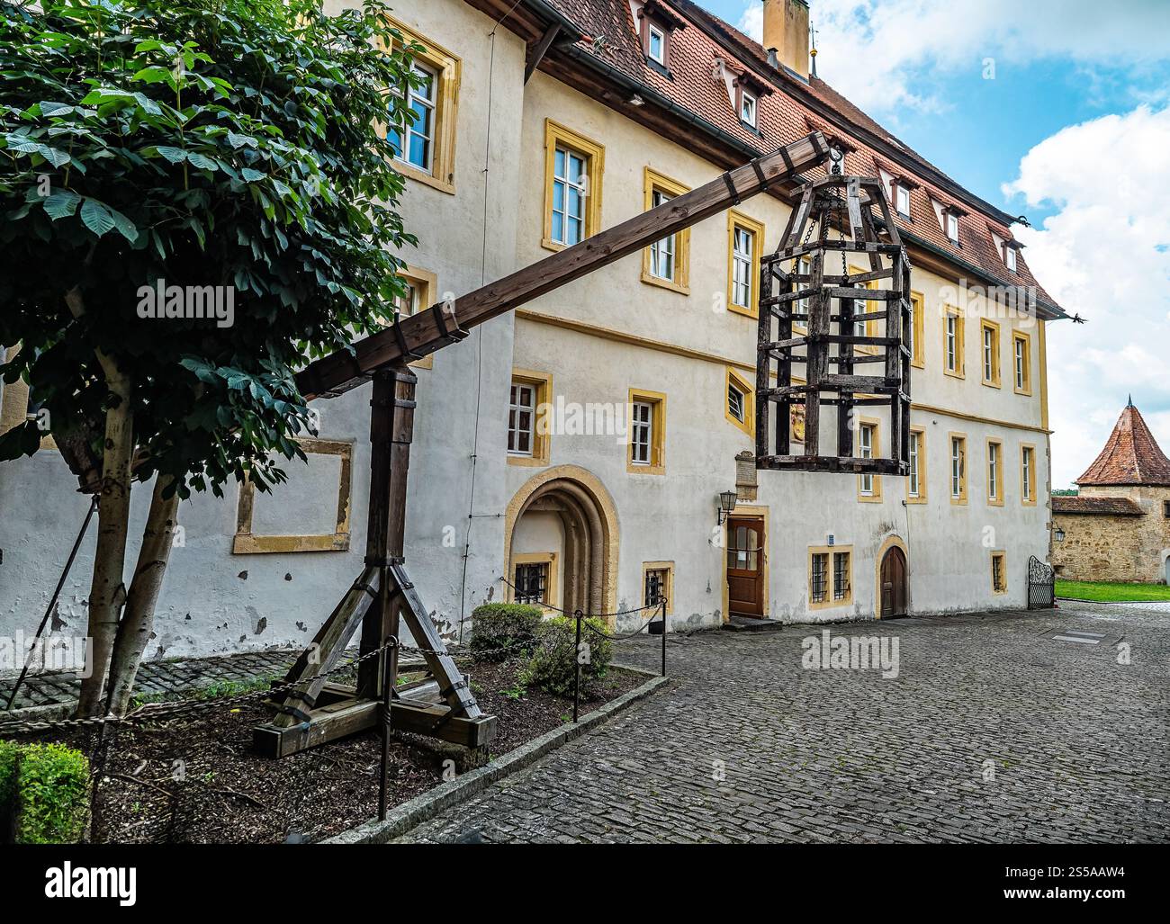 A traditional medieval contraption depicted in a serene courtyard ...