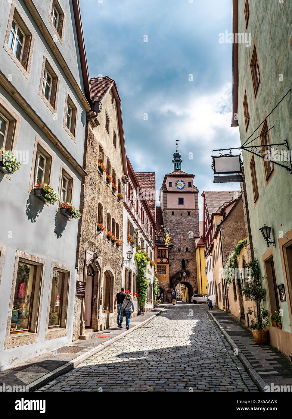 Charming medieval street featuring colorful half-timbered houses, ivy ...