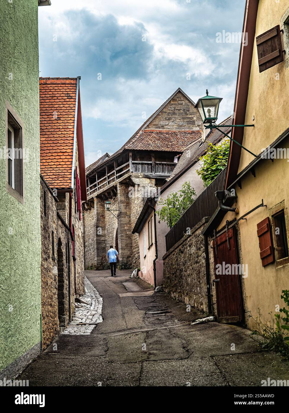Charming medieval street featuring colorful half-timbered houses, ivy ...