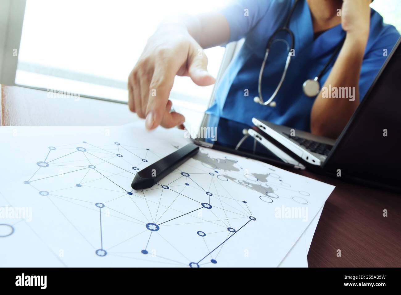 Doctor working with laptop computer in medical workspace office and ...