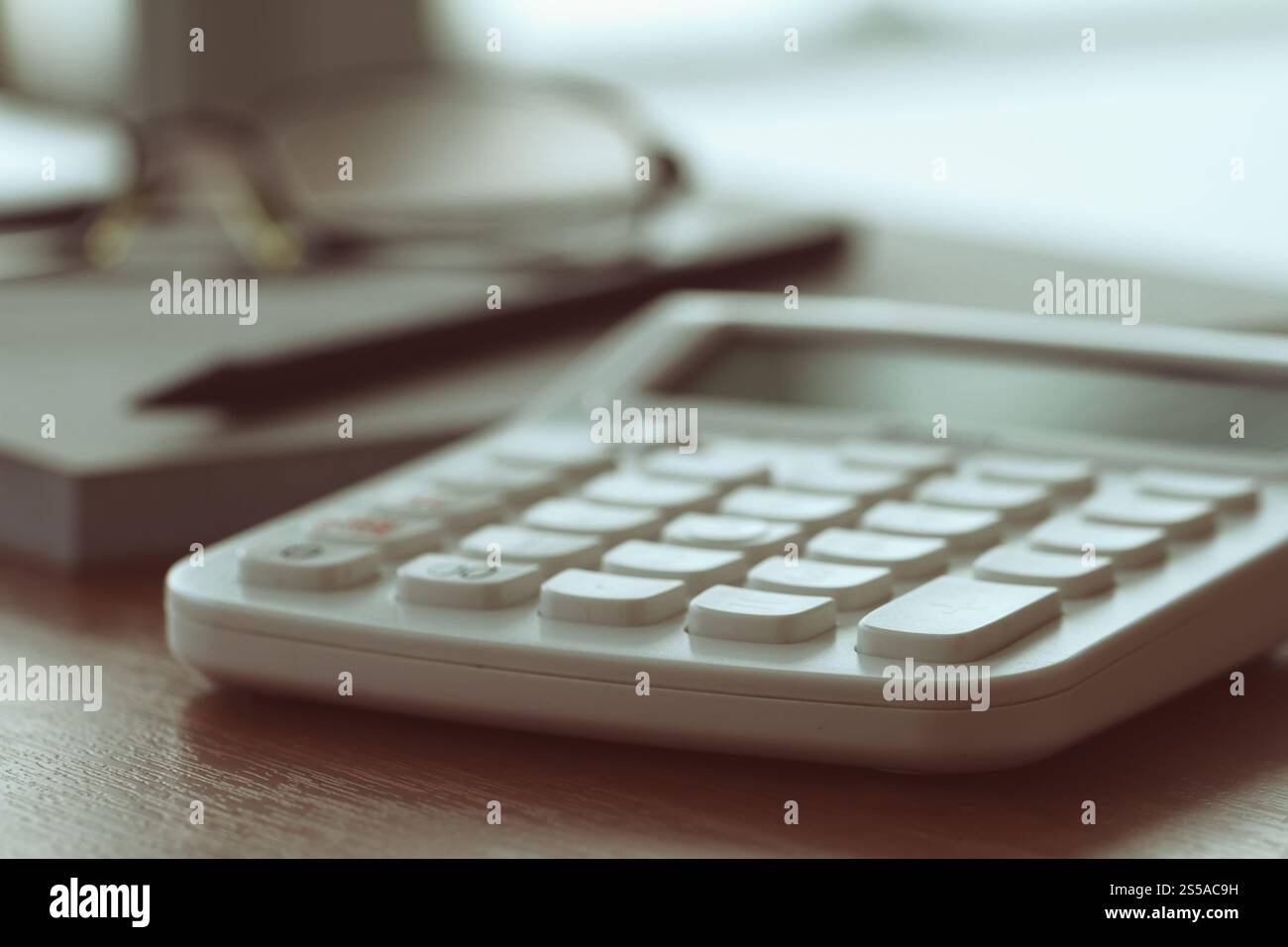 close up of business documents on office table with calculator and ...