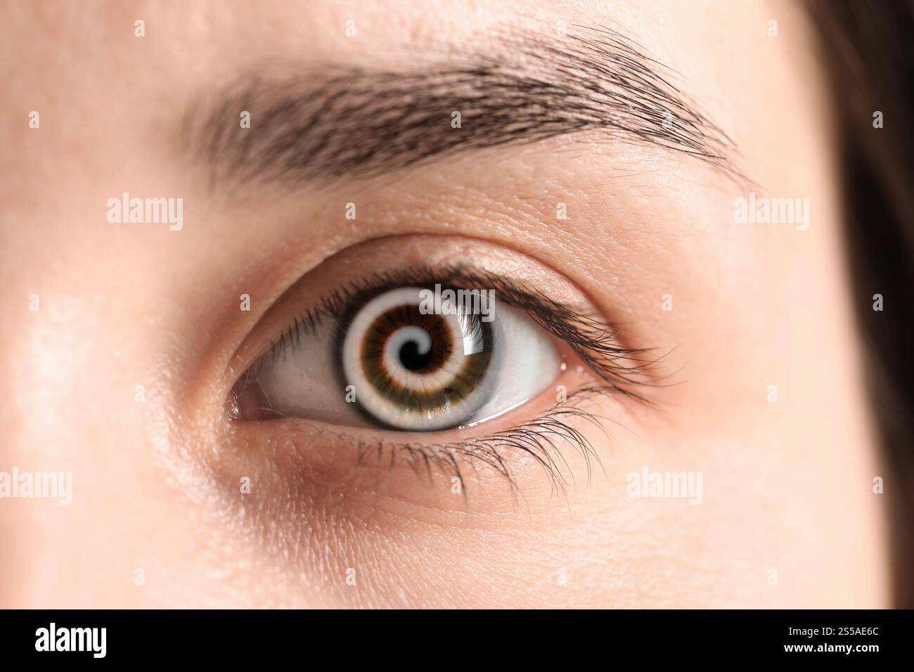 Hypnosis. Spiral symbolizing hypnotic effect in woman's eye, closeup ...