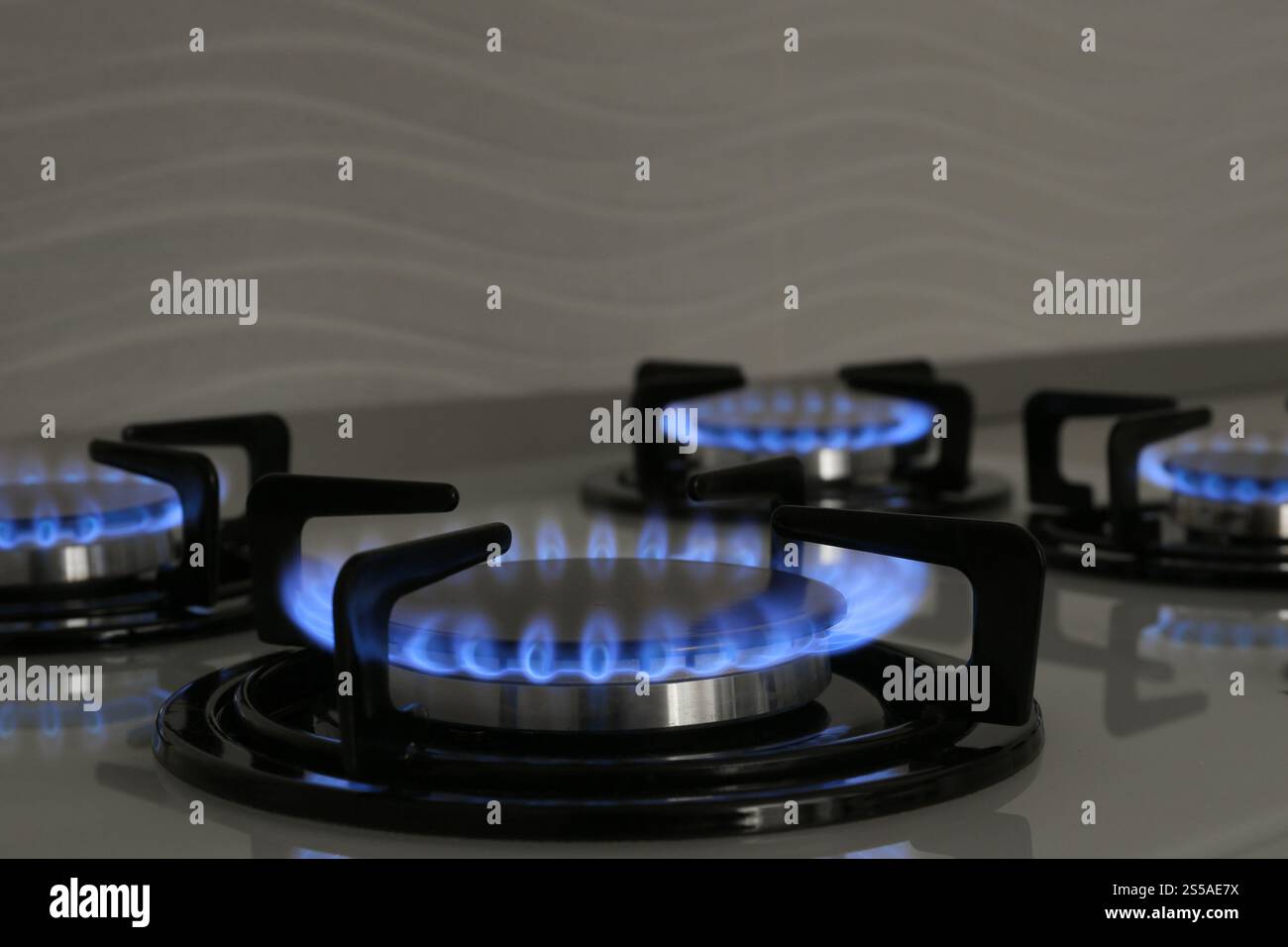 Modern gas cooktop with burning blue flames in kitchen Stock Photo - Alamy