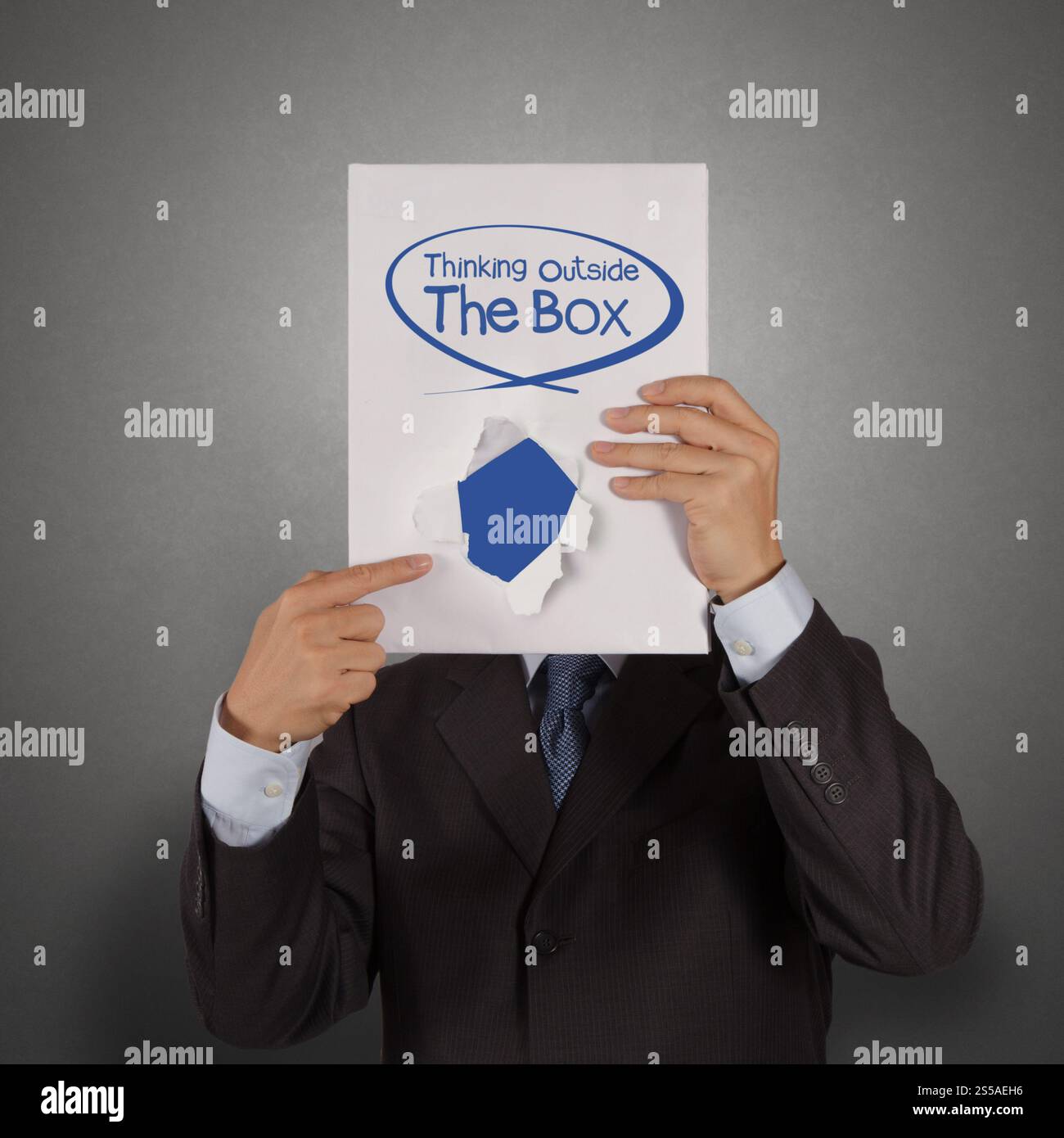 hand shows crumpled paper book and think outside the box as concept ...