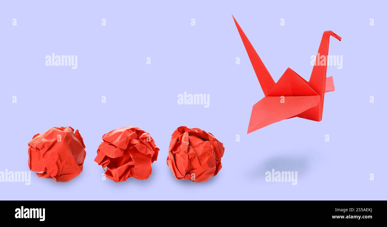 Red origami crane and crumpled paper balls on grey background, banner ...
