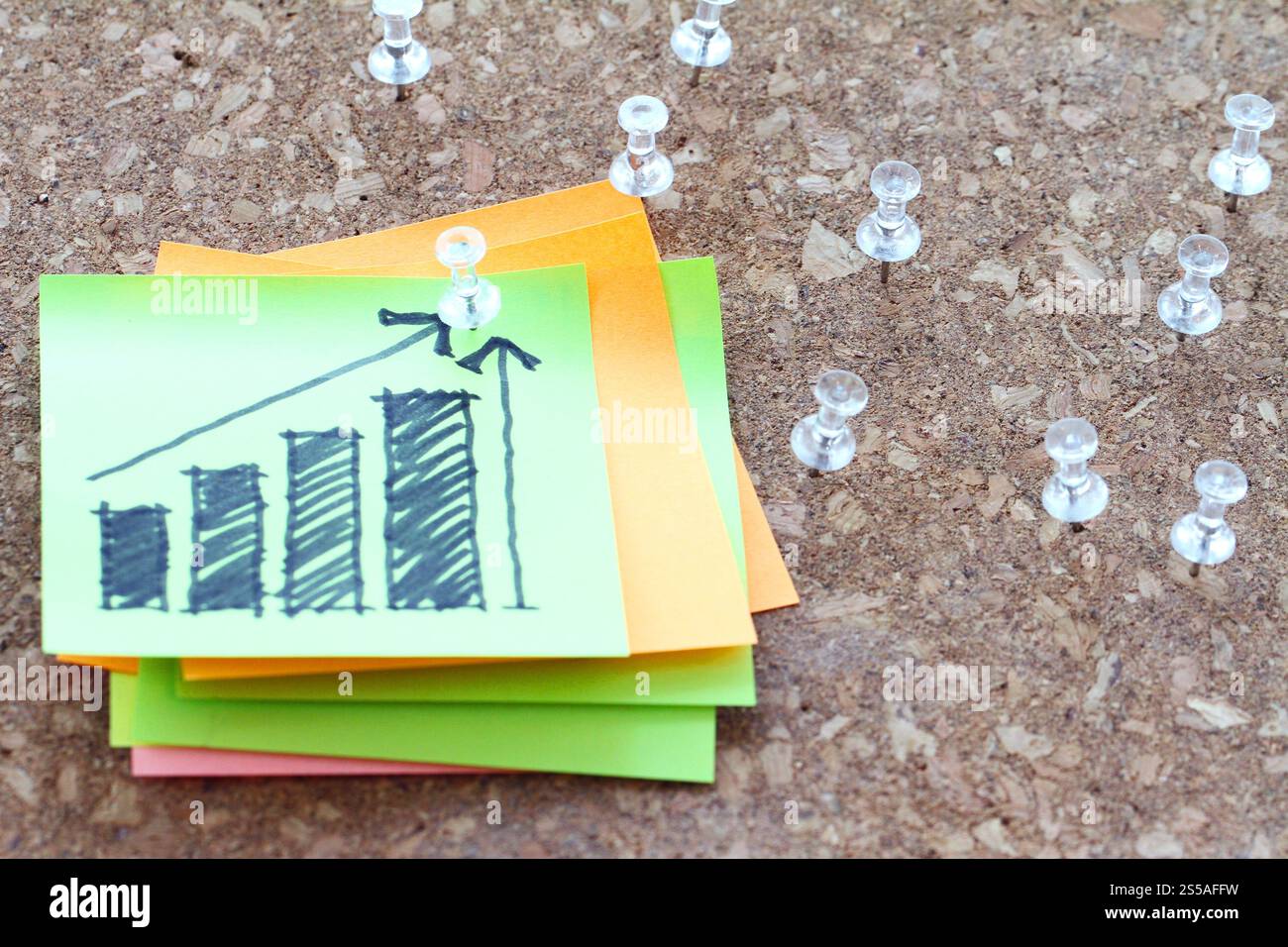 close up of pin and hand drawn business strategy graph chart on sticky ...