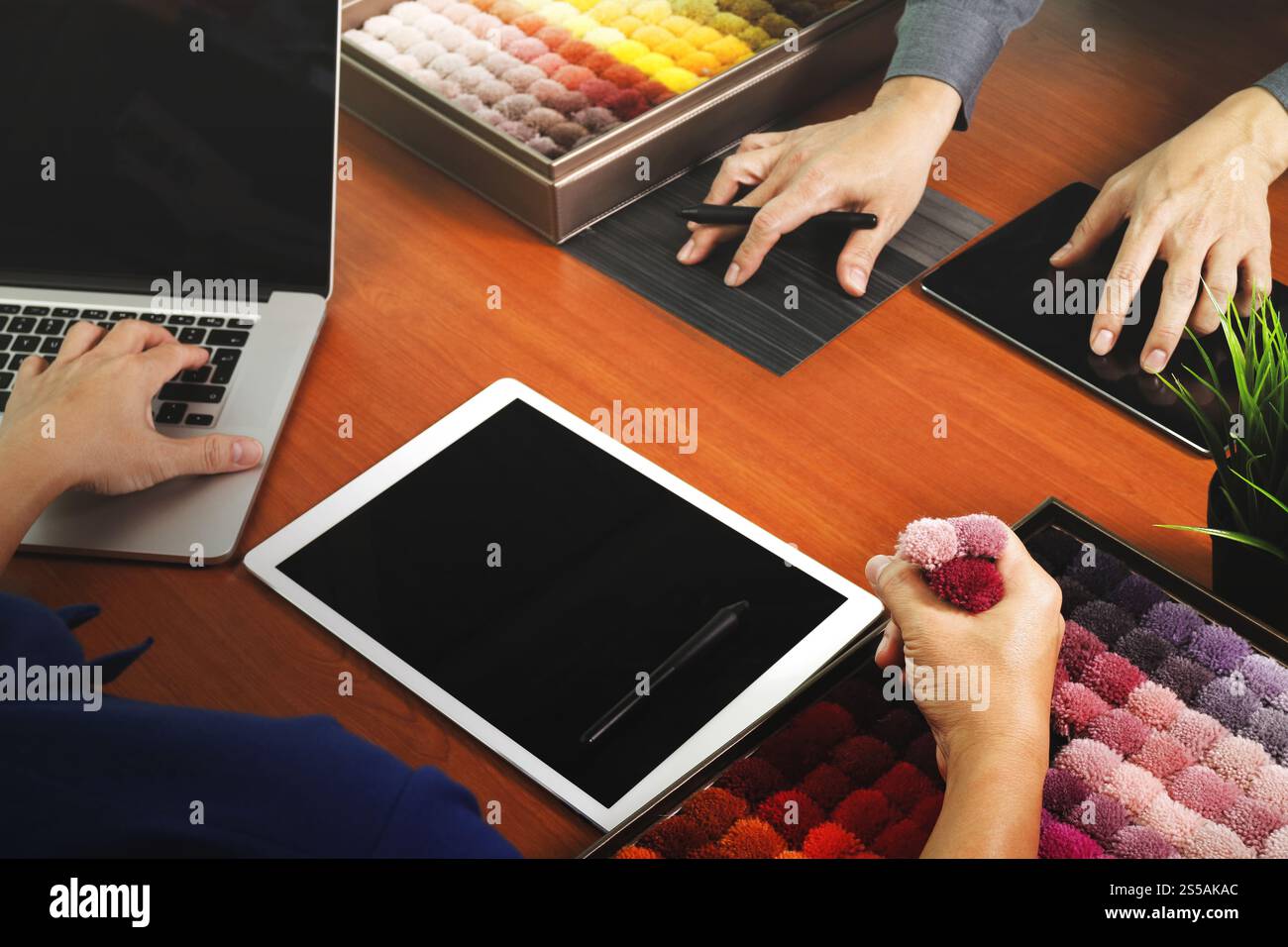 top view of two colleagues interior designers discussing data with new ...