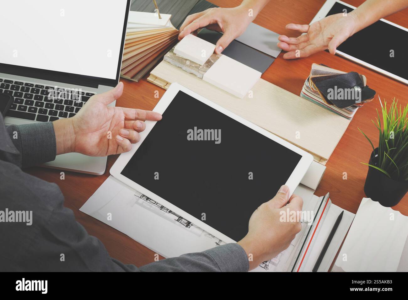 top view of two colleagues interior designers discussing data with ...