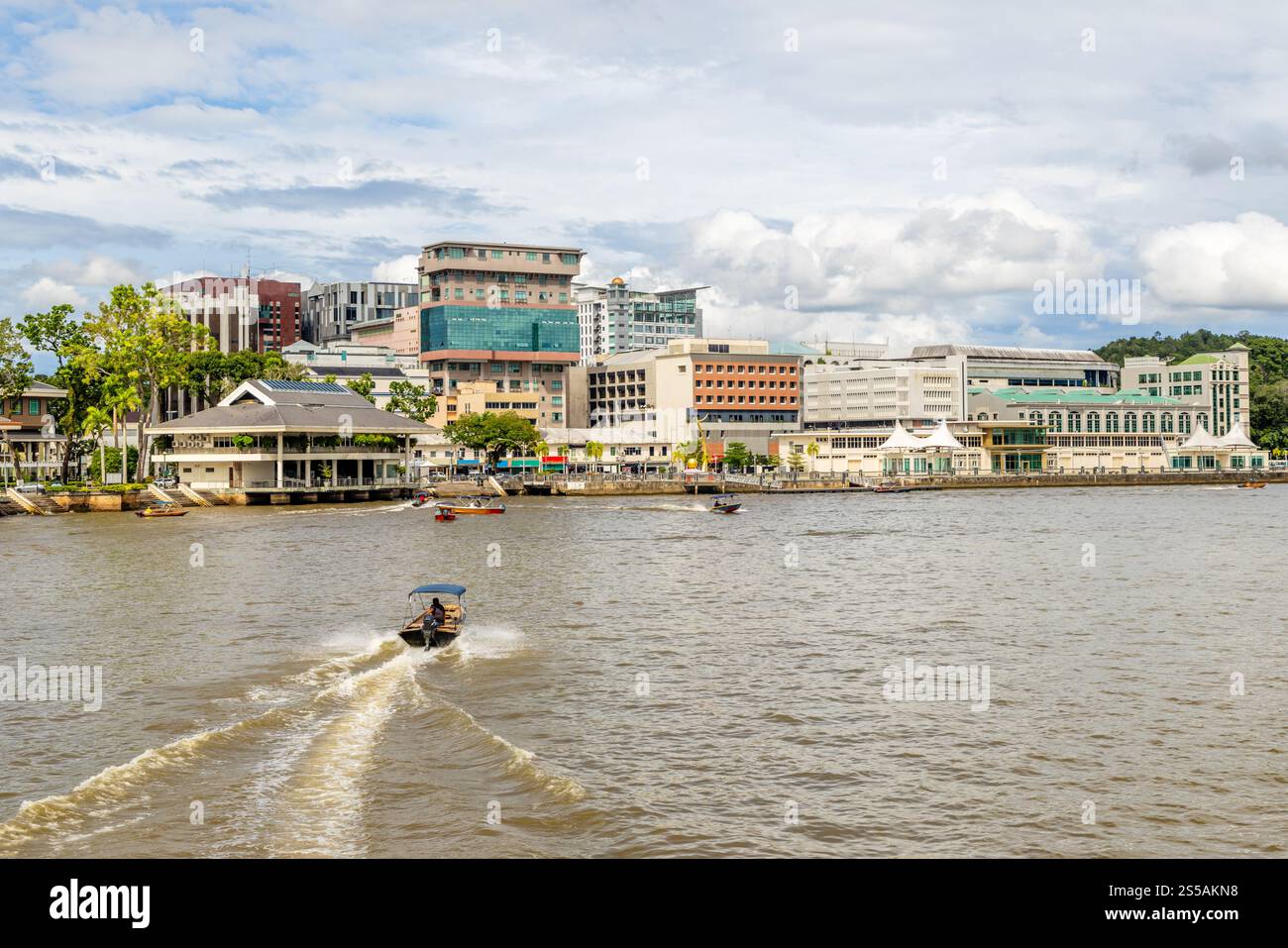 Brunei river with motor boats and promenade city street with modern ...