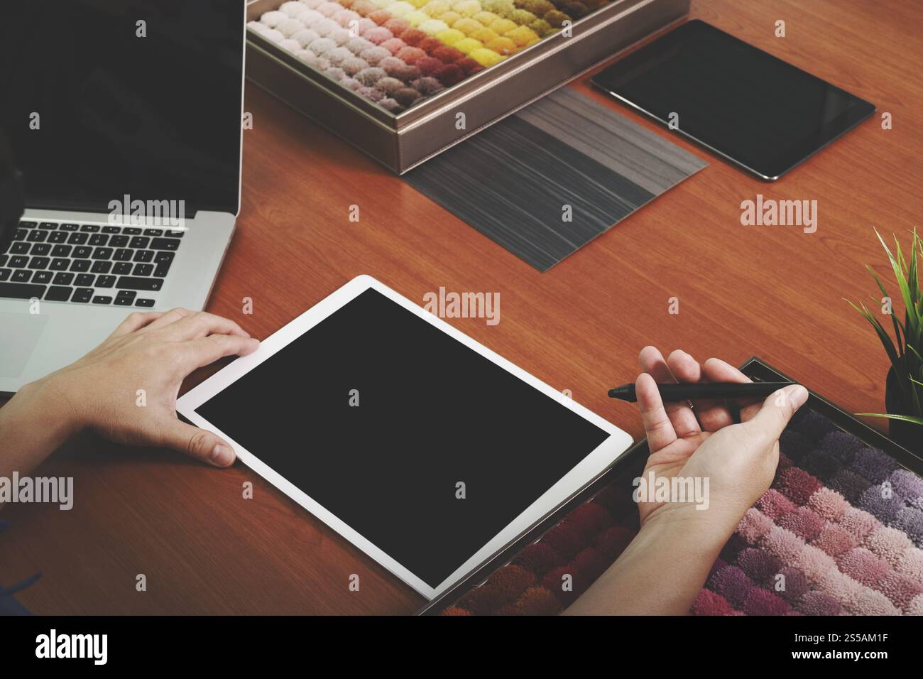 top view of Interior designer hand chosing carpet sample with blank new ...