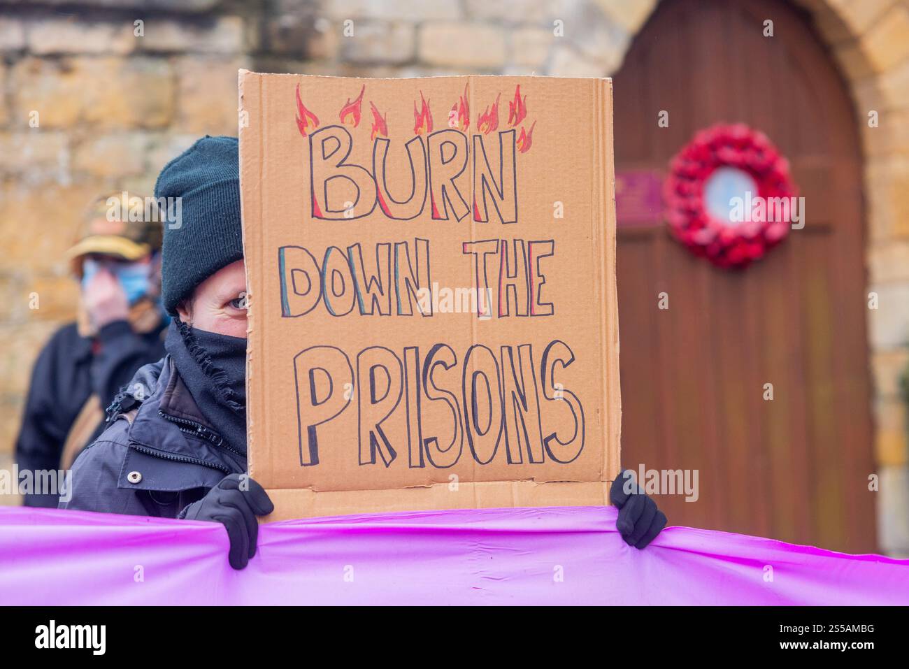 Lincoln, UK. 13 JAN, 2025. "Burn down the prisons" sign as activists ...