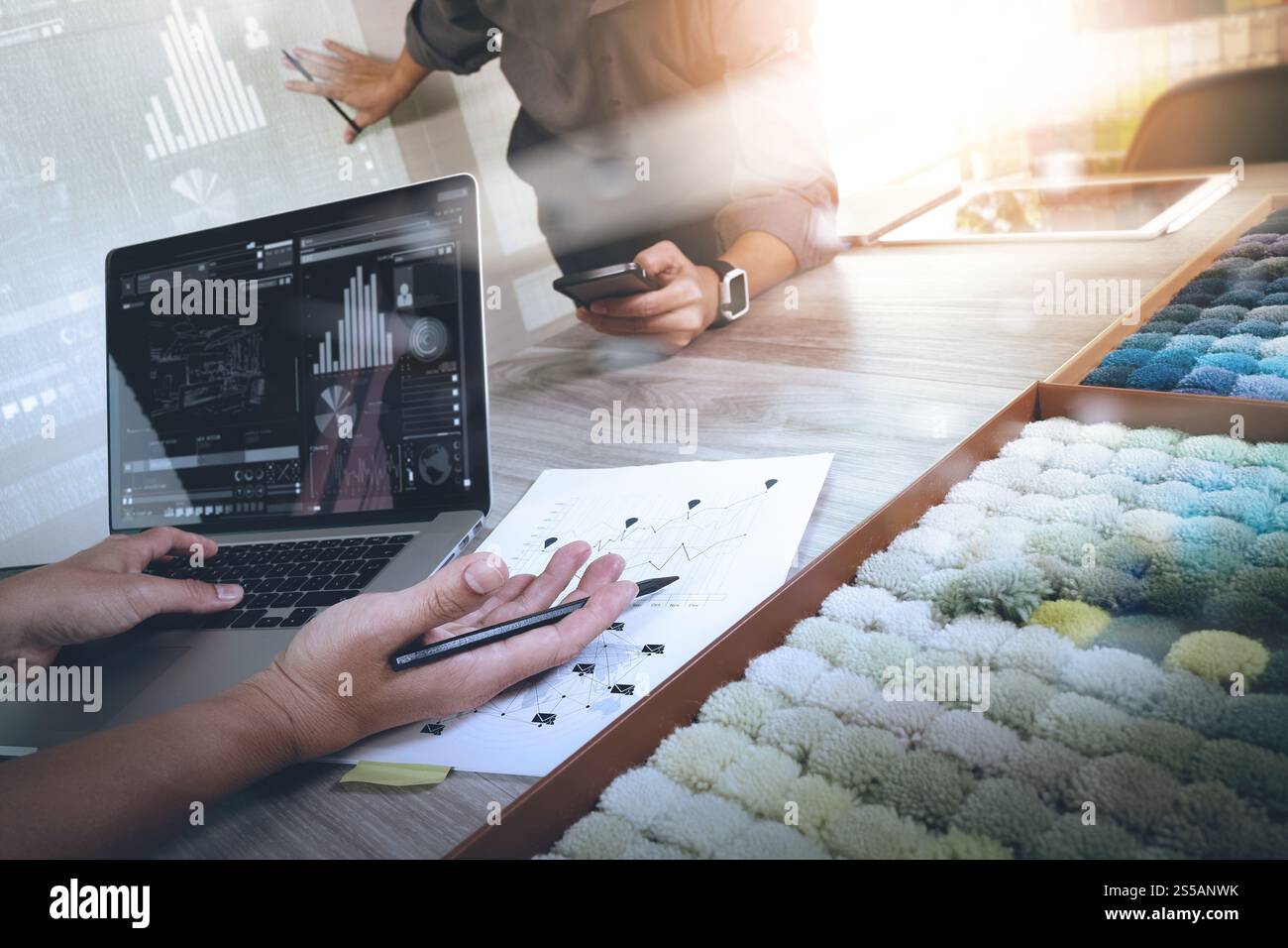 colleagues interior designers discussing data with new modern computer ...