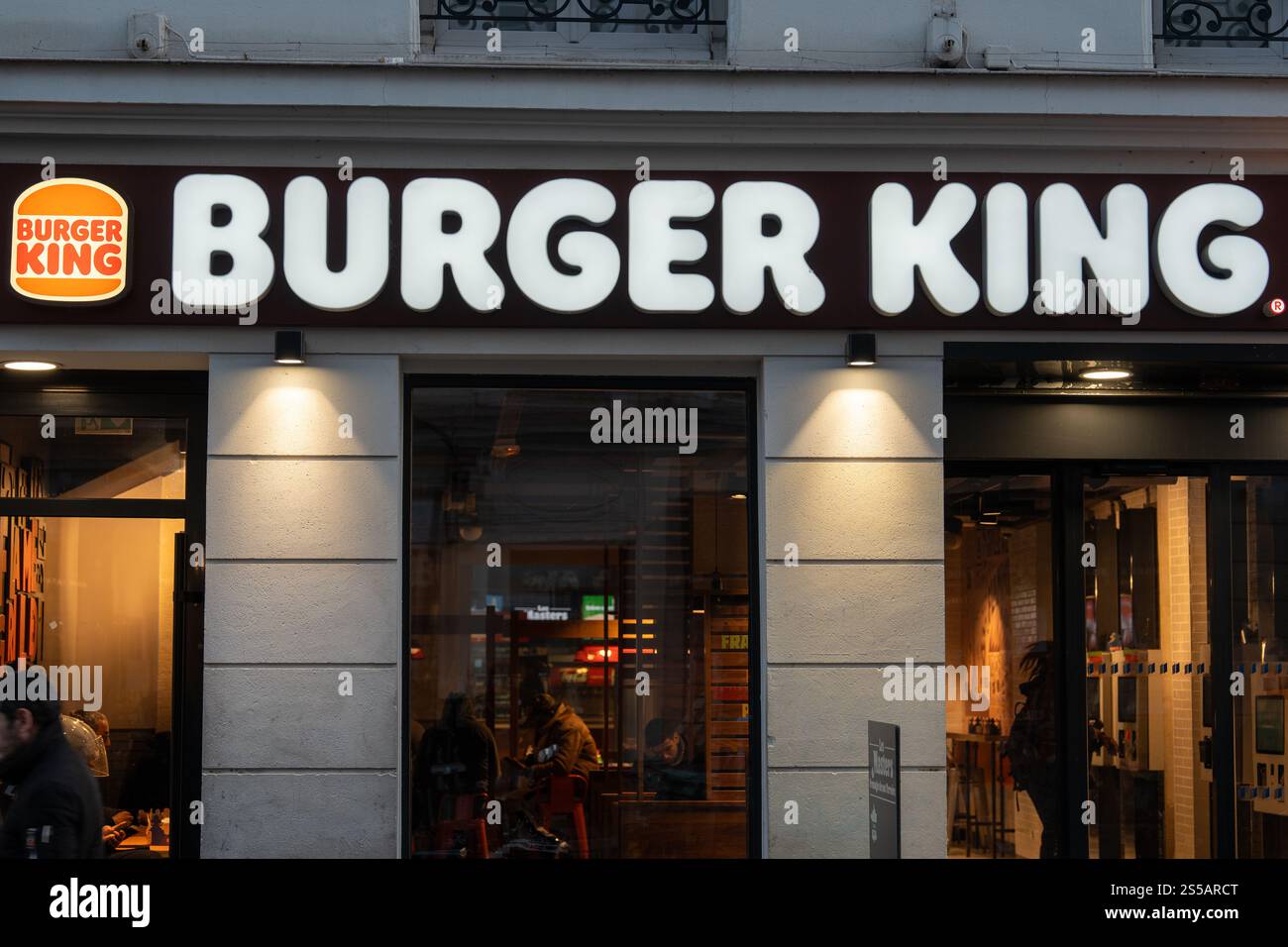 Fast-food dining experience in Paris with patrons enjoying their meals ...