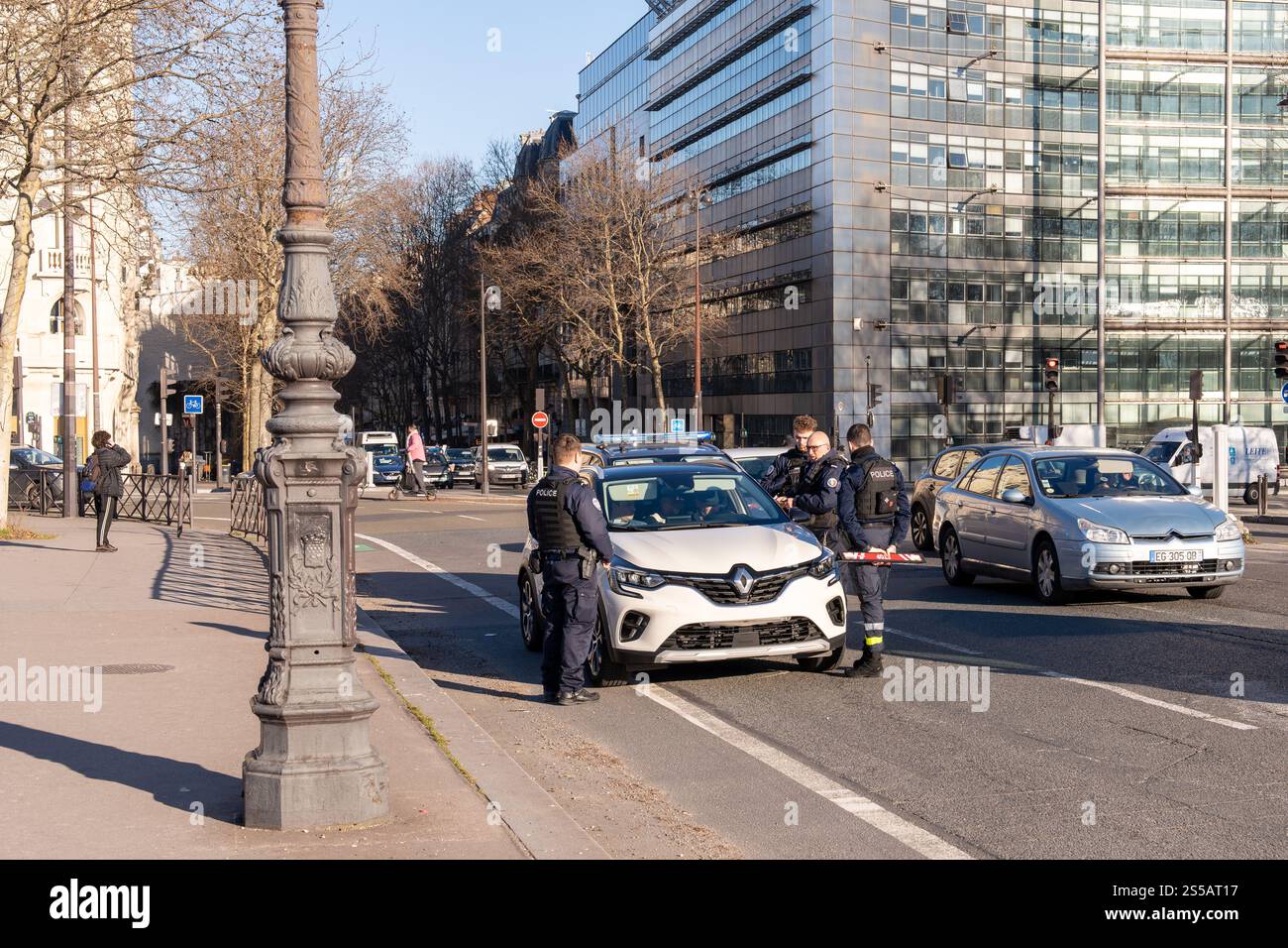 Two police officers conducting a traffic stop in Paris on January 13 ...
