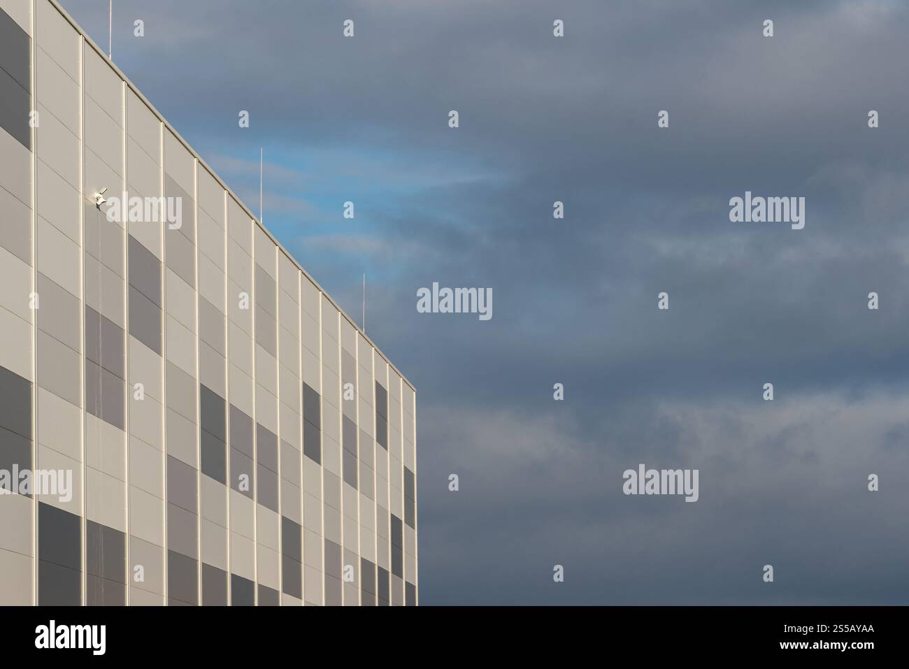A large contemporary building features a geometric facade with gray ...