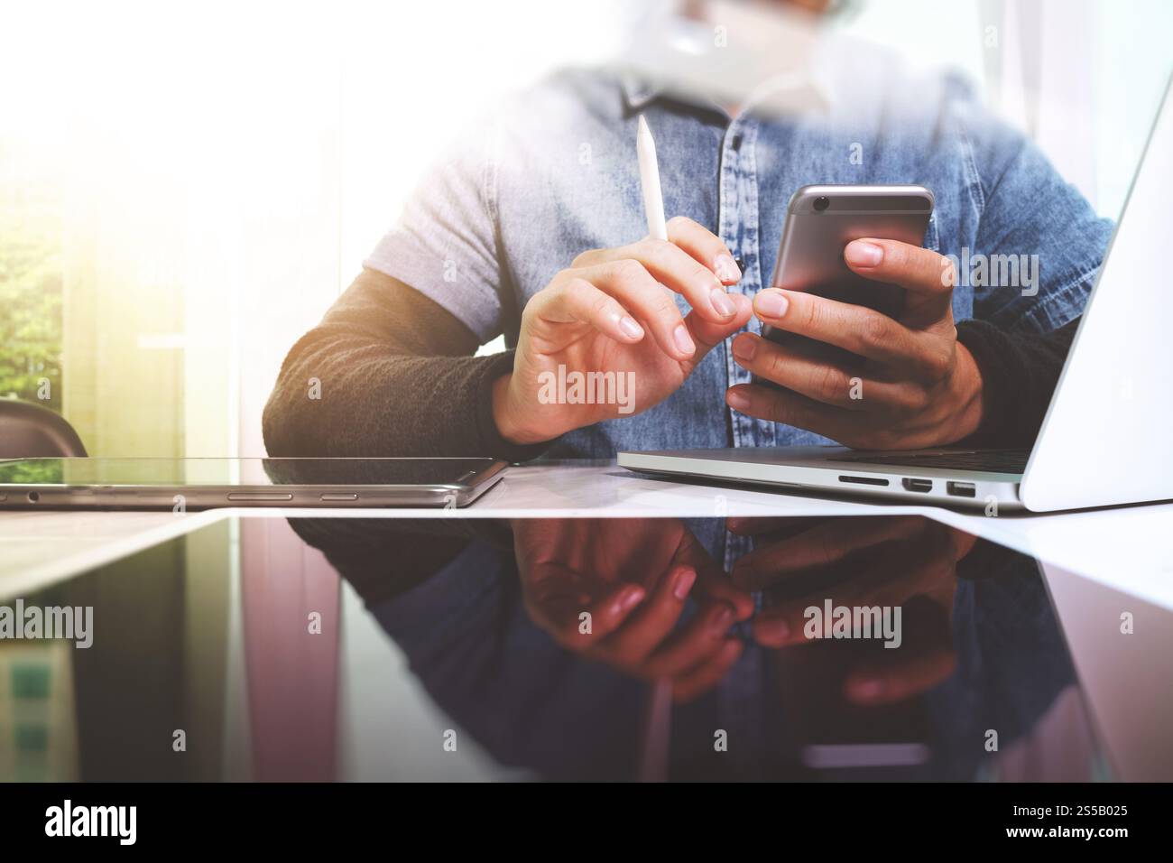 Designer hand working in creative studio. Using modern laptop digital tablet smart phone ...