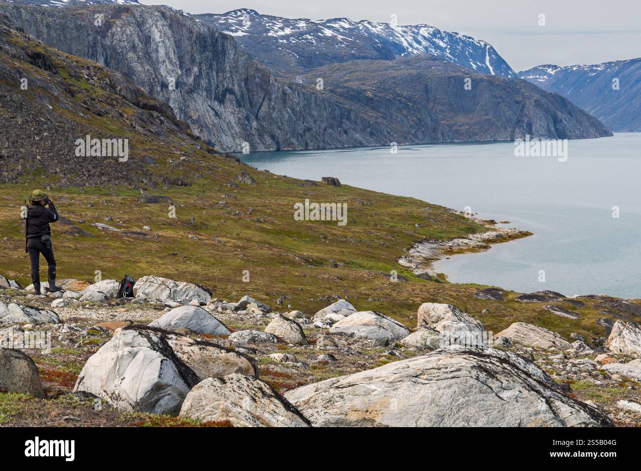 Female tour leader with a rifle keeping a look out to protect tourists ...