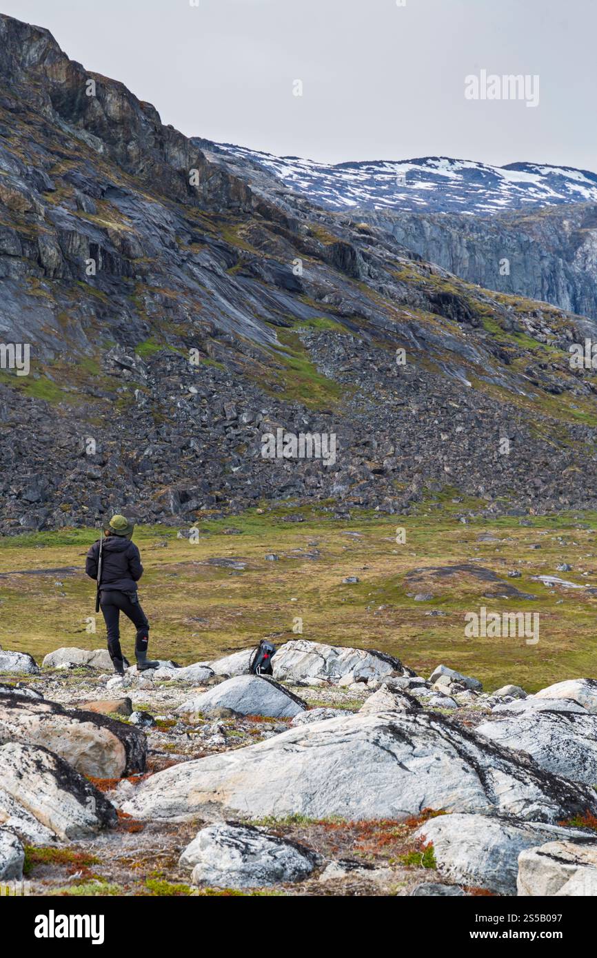 Female tour leader with a rifle keeping a look out to protect tourists ...