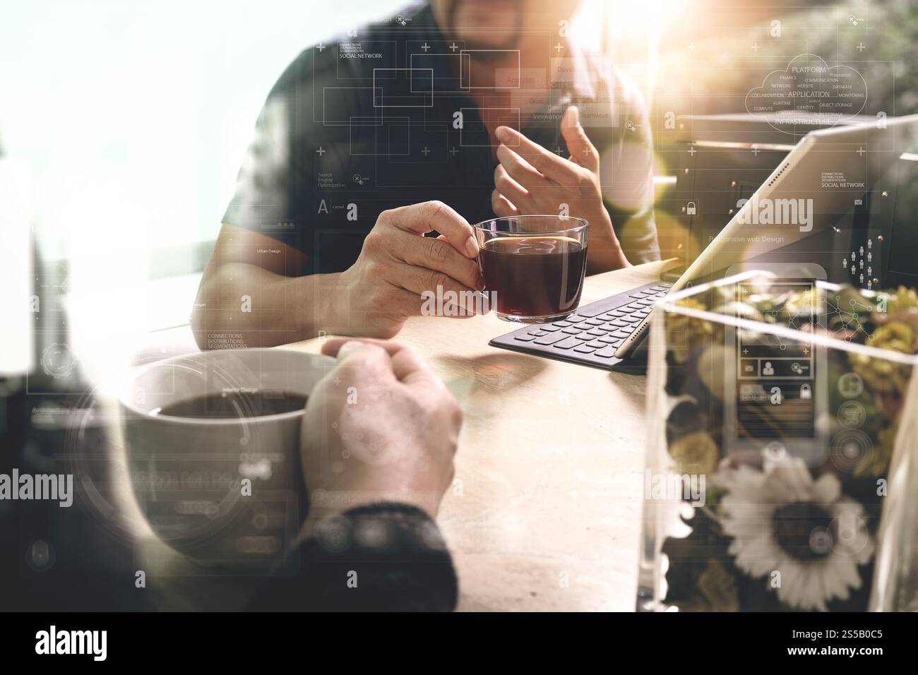 Office coffee break with two designer colleagues sitting chatting over ...