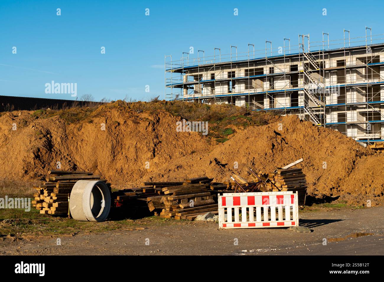 Construction work is underway at a site filled with mounds of earth ...