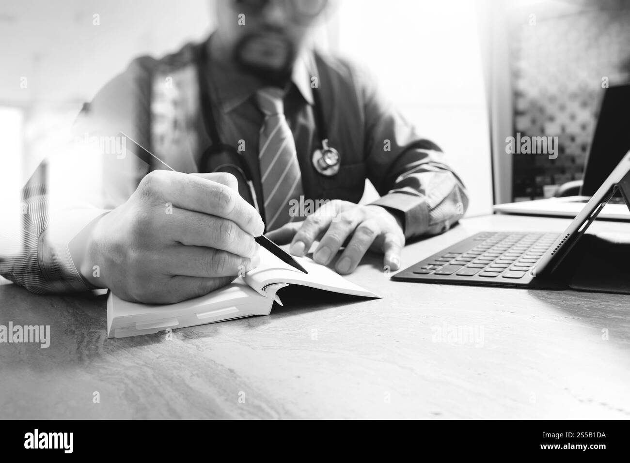 Doctor on desk Black and White Stock Photos & Images - Alamy