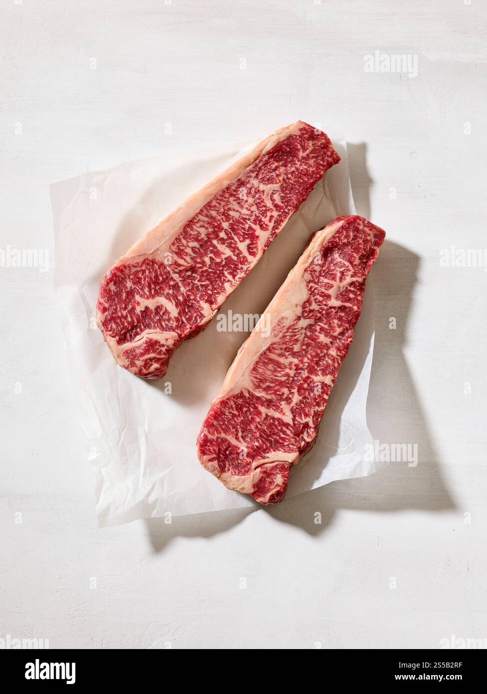 fresh raw Australian Wagyu steak on light sunny kitchen table surface ...