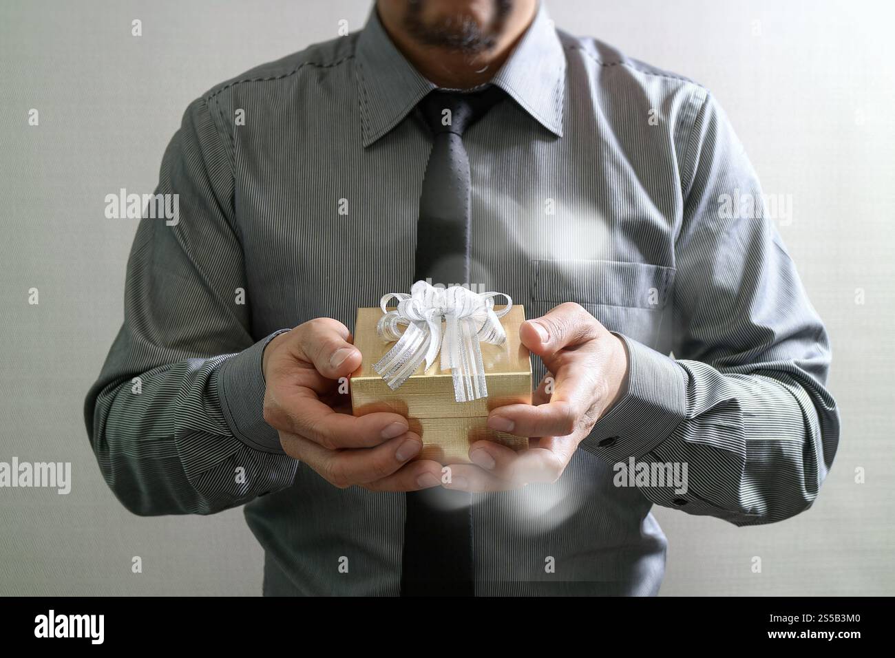 gift giving,businessman hand holding a gift box in a gesture of giving ...