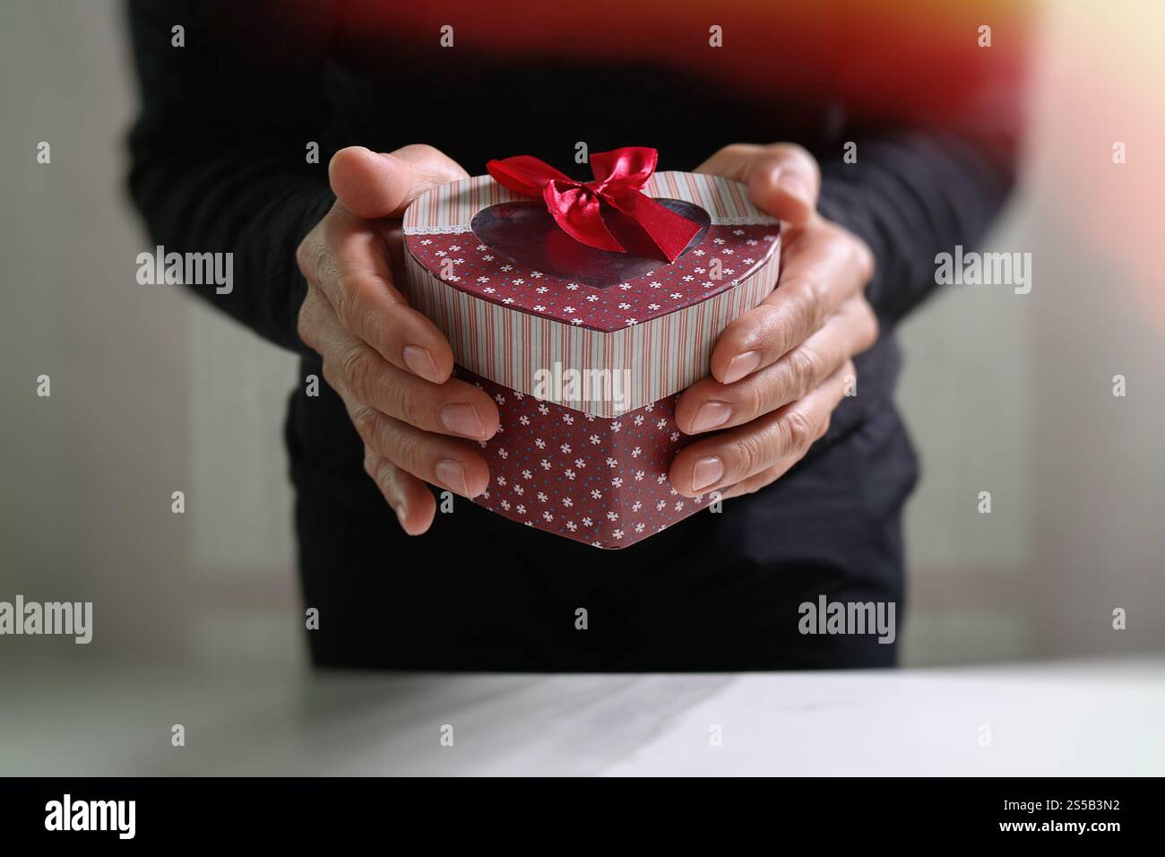 gift giving,man hand holding a gift box in a gesture of giving.blurred ...