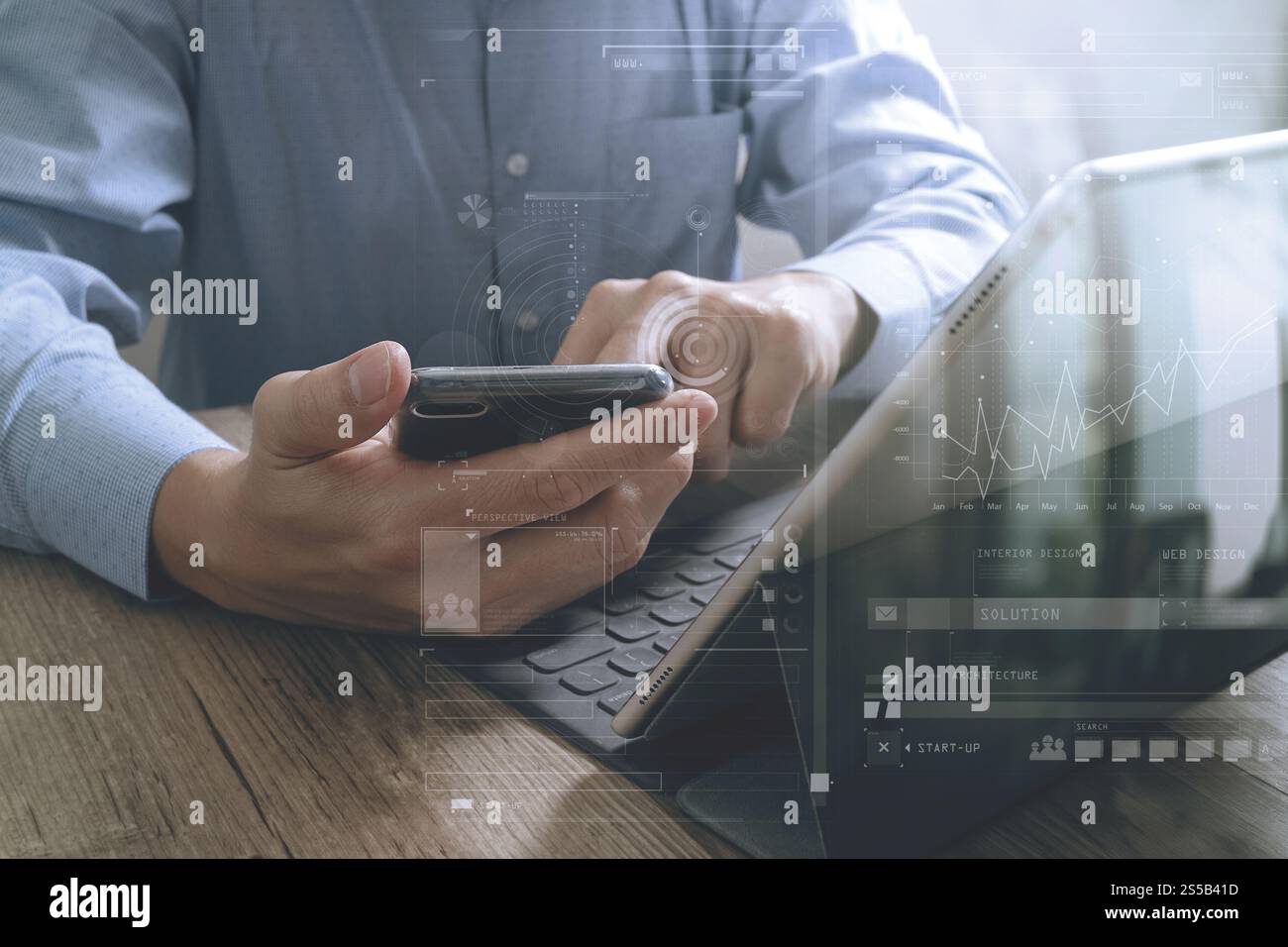 success businessman using smart phone,digital tablet docking smart keyboard,on wooden desk,icons ...