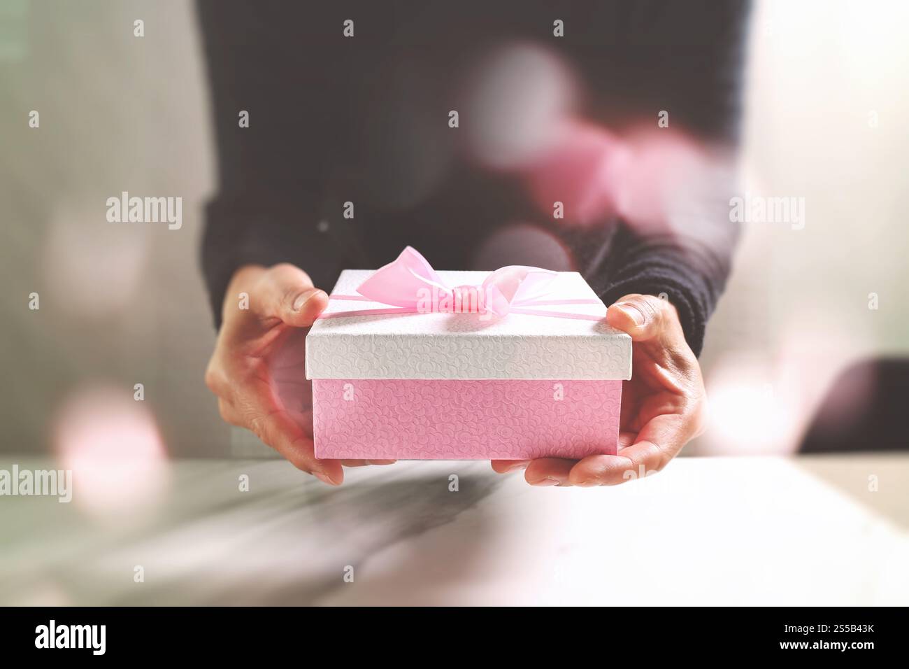 gift giving,man hand holding a gift box in a gesture of giving.blurred ...