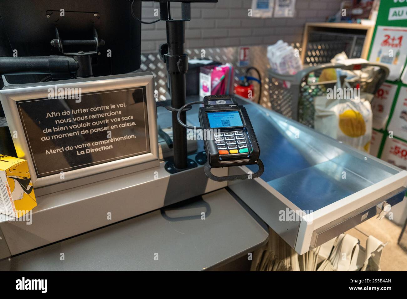 Checkout station in Paris with payment terminal on January 13, 2025 ...