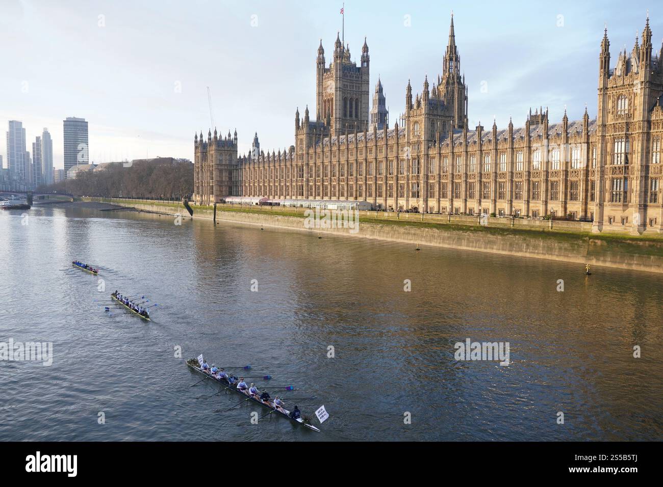 MPs and Olympians row past the Houses of Parliament in London as they ...