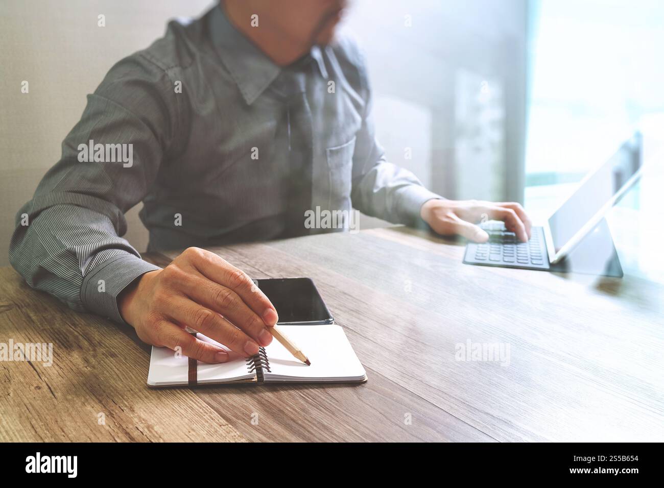 businessman working with new start up project.using smart phone digital tablet docking smart ...