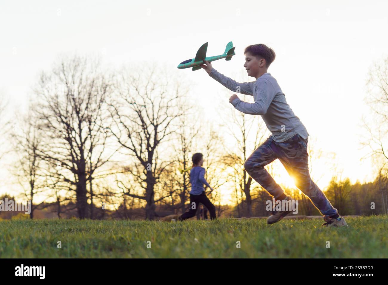 Cute teenage airplane modeler launches his model airplane at ...