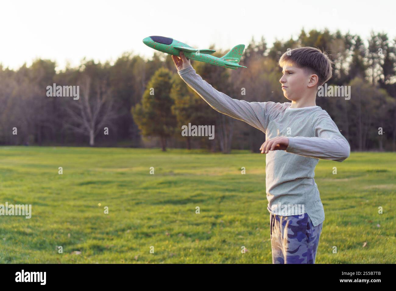 Teenage aircraft modeler launches his model airplane at aerial ...