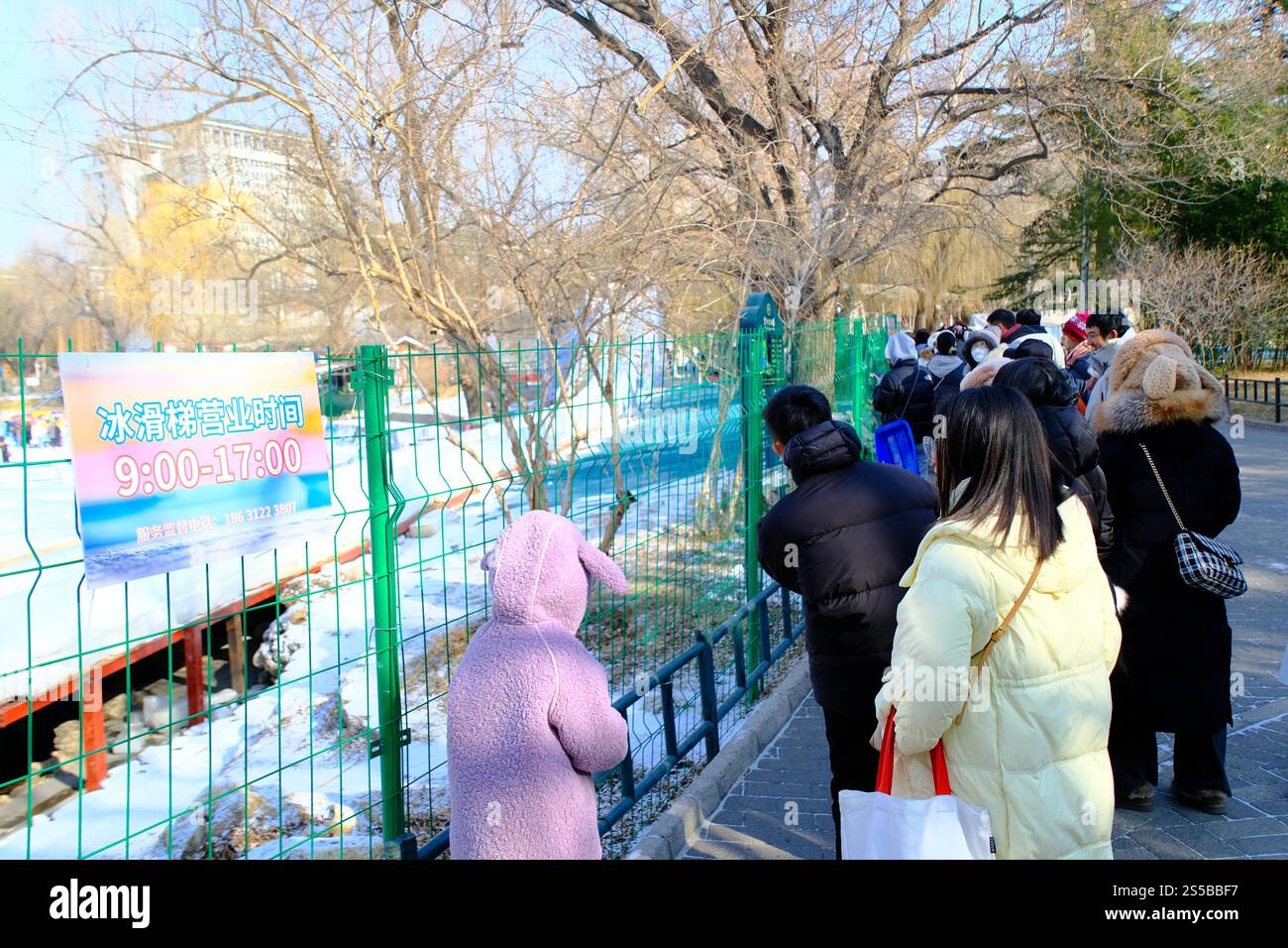Tourists experience the long ice slide at Purple Bamboo Park in Beijing ...