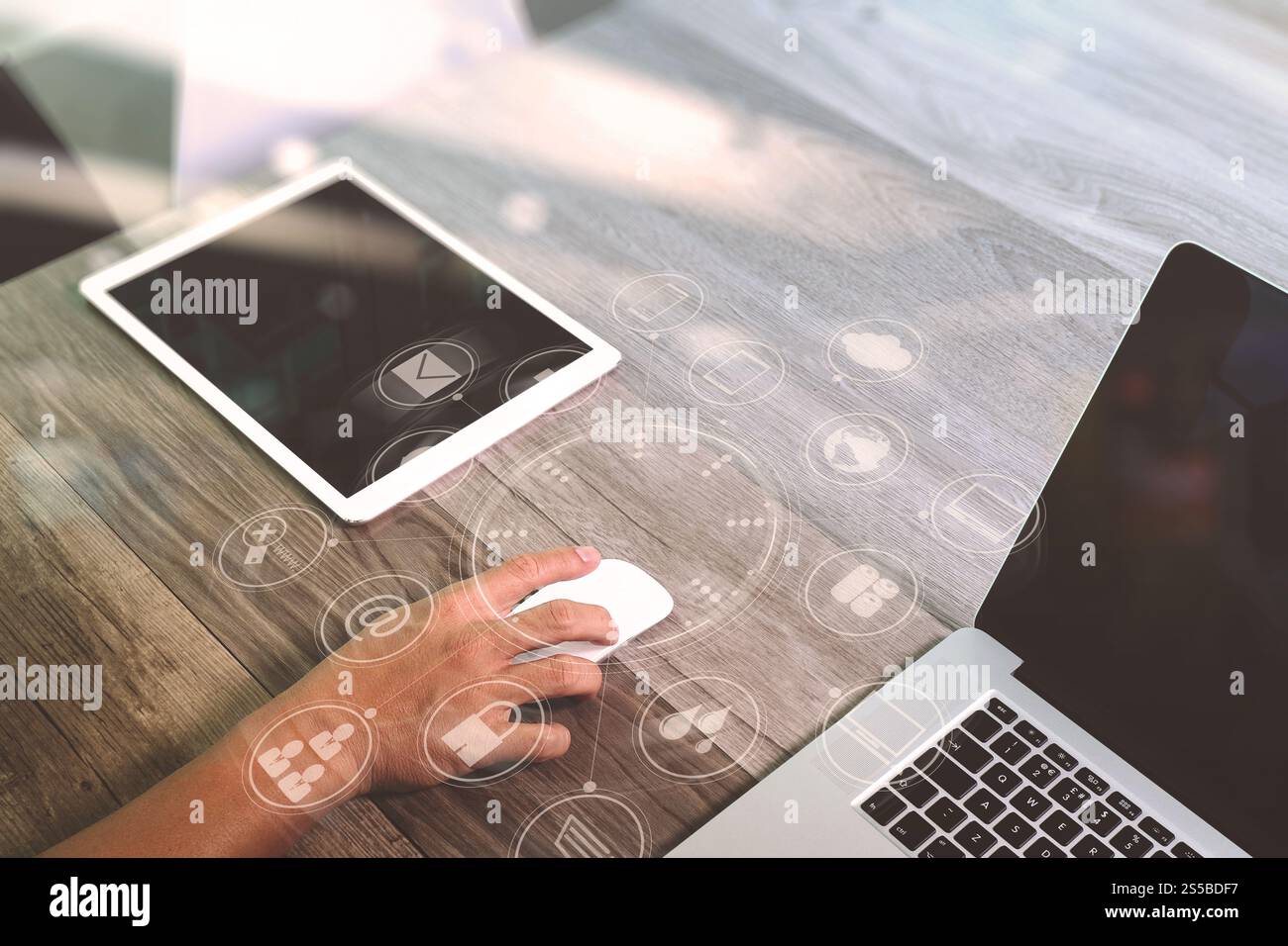 hand using mouse and laptop computer with digital tablet in modern ...