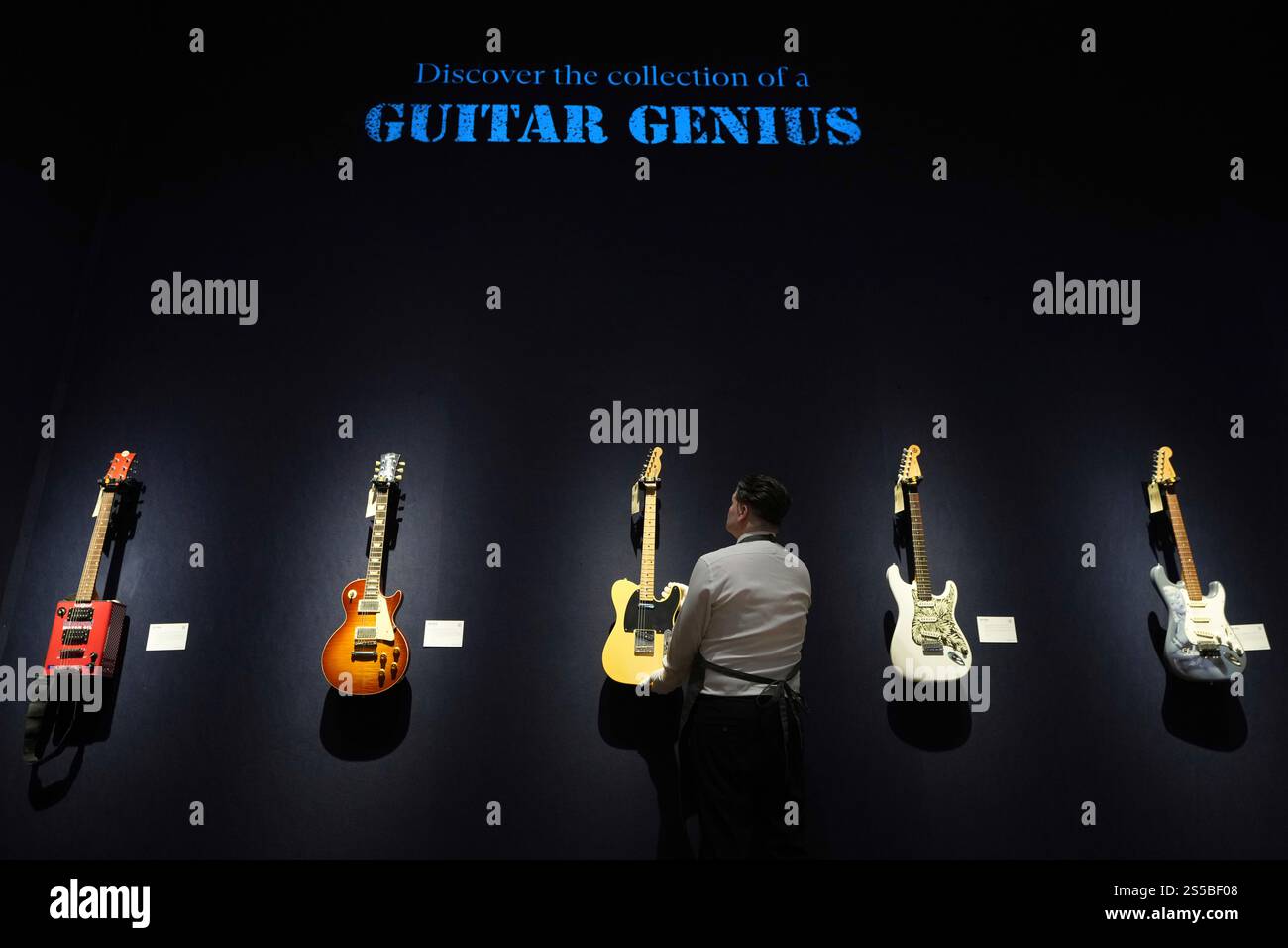 An art handler arranges guitars ahead of the Jeff Beck - The Guitar ...