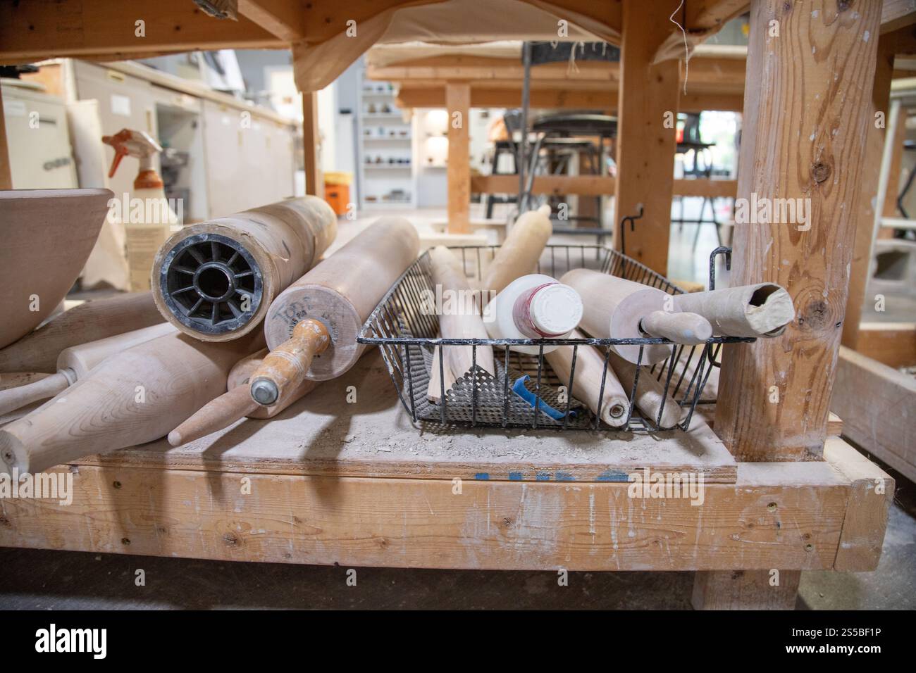 Close-up of assorted rolling pins and pottery tools in a pottery studio ...