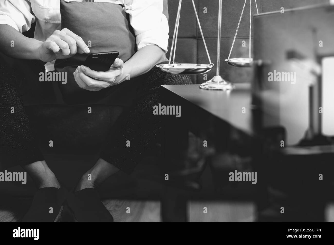 Justice and Law context.Male lawyer hand sitting on sofa and working with smart phone,digital ...