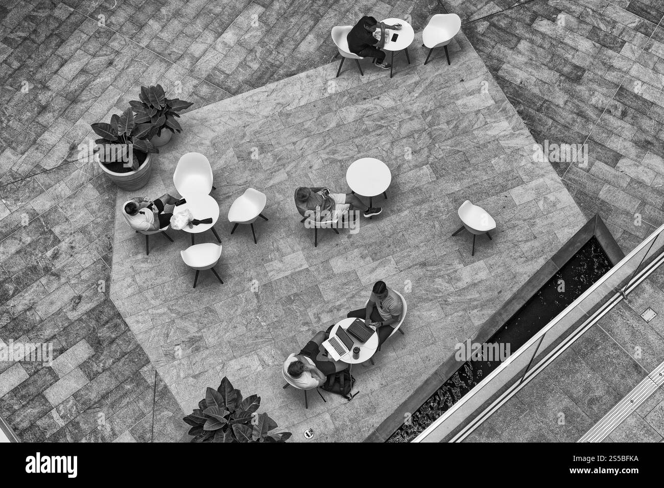 an aerial view of an outdoor seating area with several round tables and ...