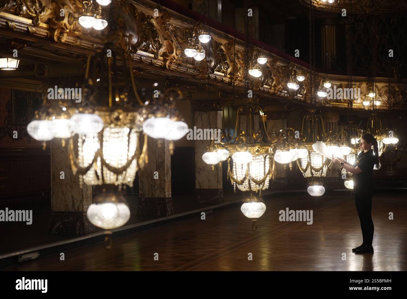 Tower ballroom team member Jennifer Allinson cleans one of the twelve ...